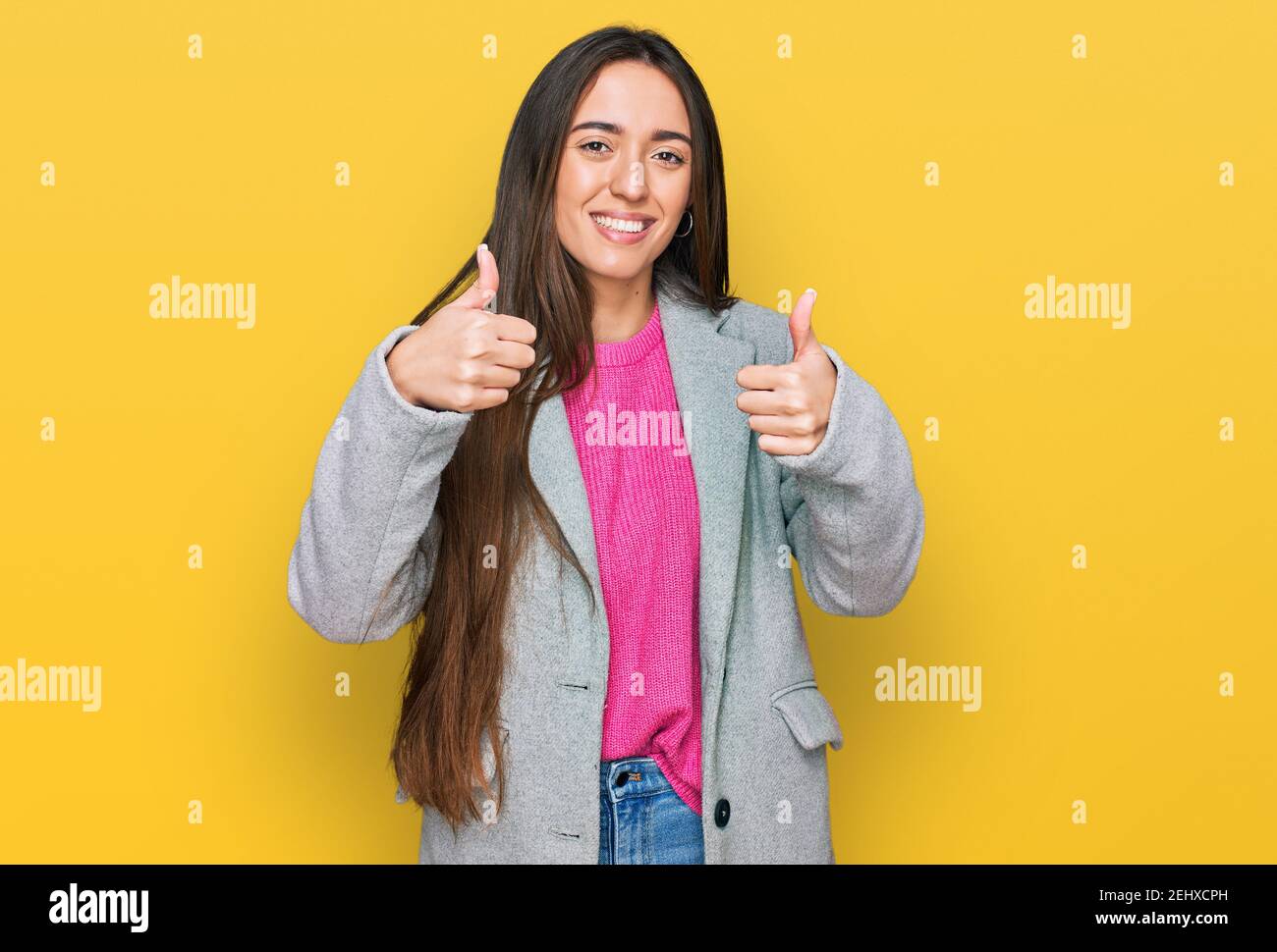 Young hispanic girl wearing business clothes success sign doing ...