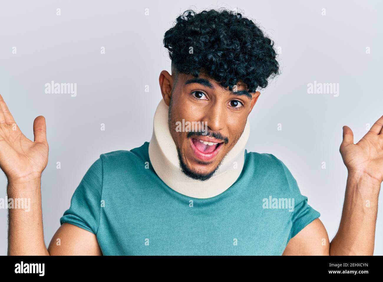 Young arab handsome man wearing cervical neck collar celebrating ...