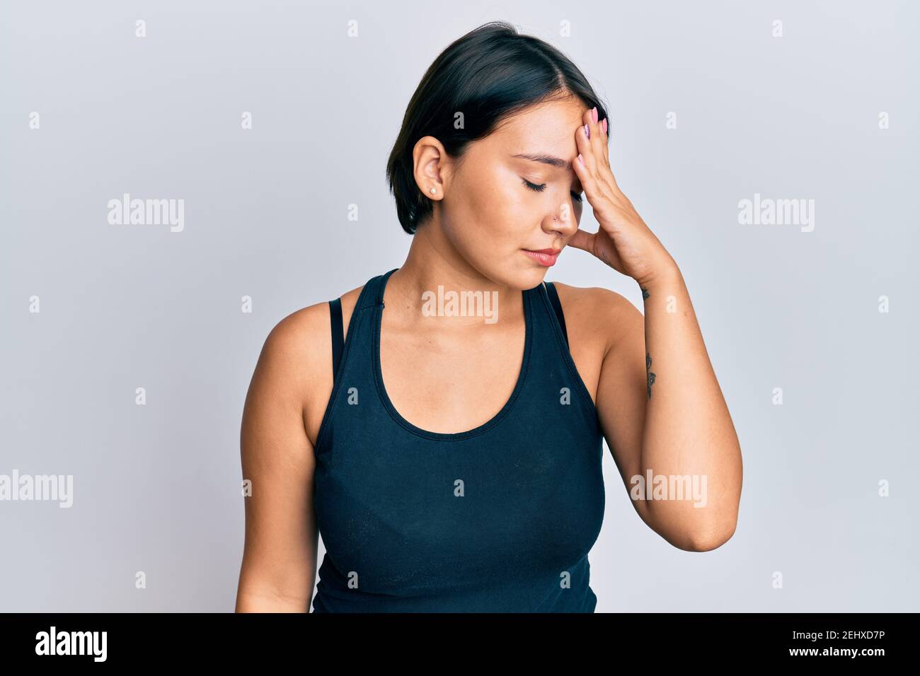 Beautiful young woman with short hair wearing casual clothes surprised ...