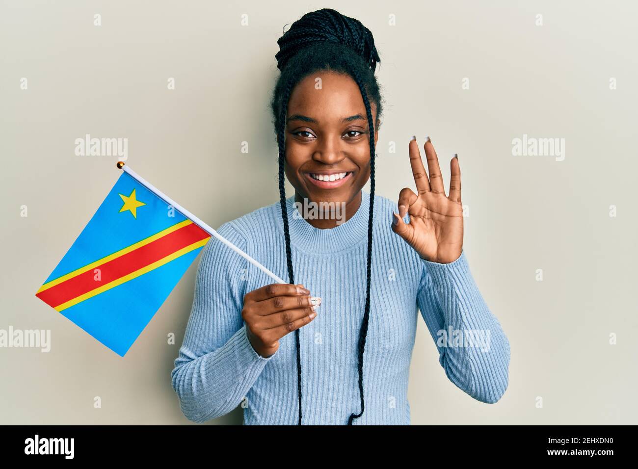 African american woman with braided hair holding democratic republic of ...