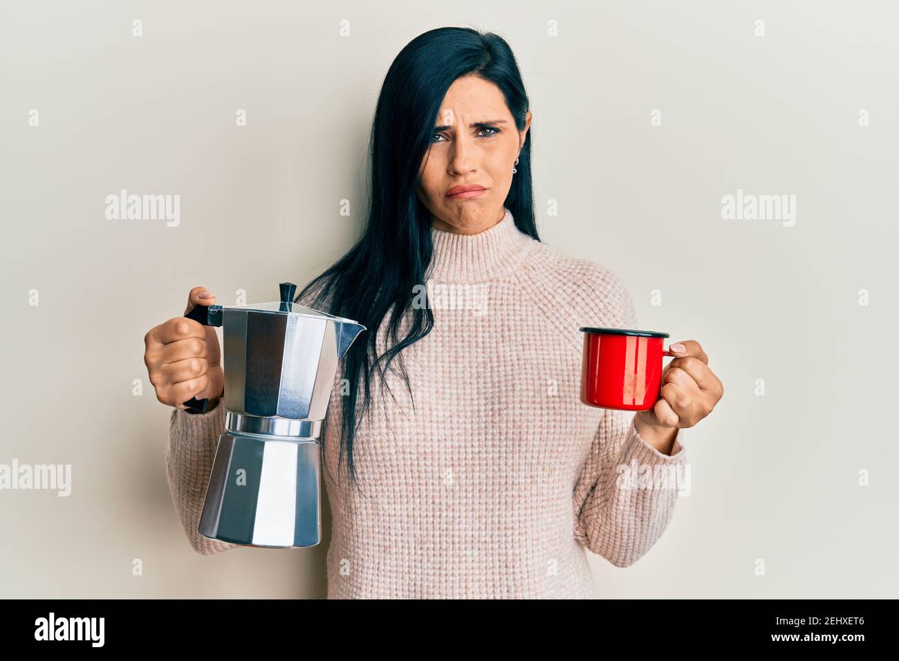 Young caucasian woman drinking italian coffee depressed and worry for ...