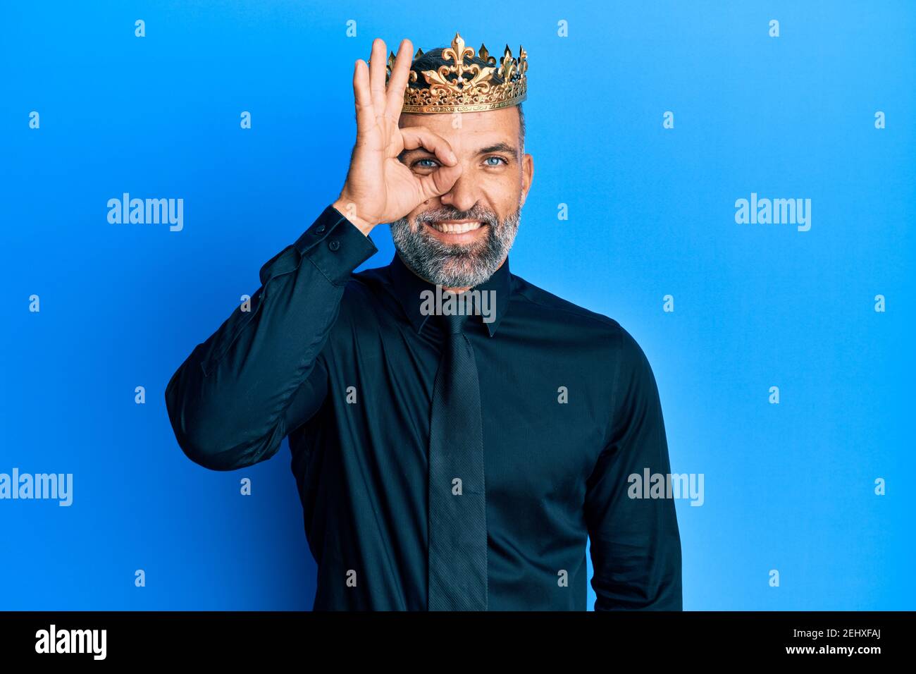 Middle age handsome business man wearing king crown smiling happy doing ...