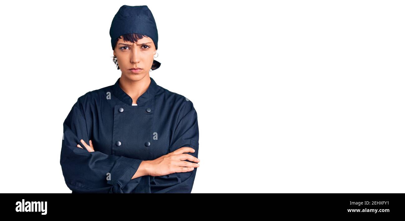 Young brunette woman with short hair wearing professional cook uniform ...