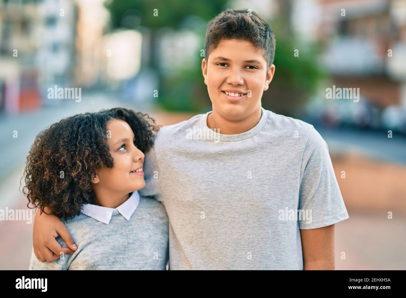 Adorable latin brother and sister hugging at the park Stock Photo - Alamy