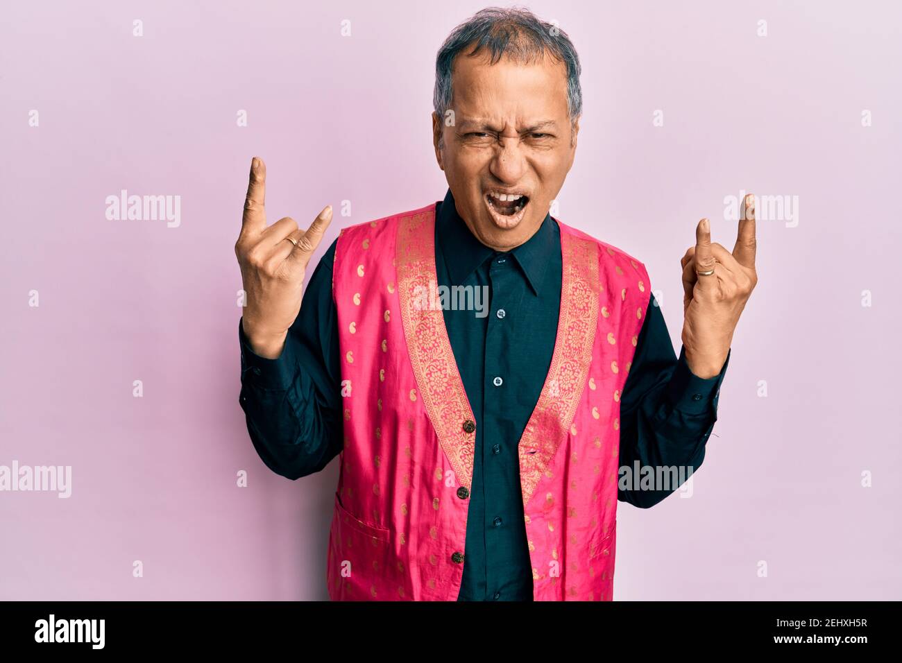 Middle age indian man wearing traditional indian clothes shouting with ...