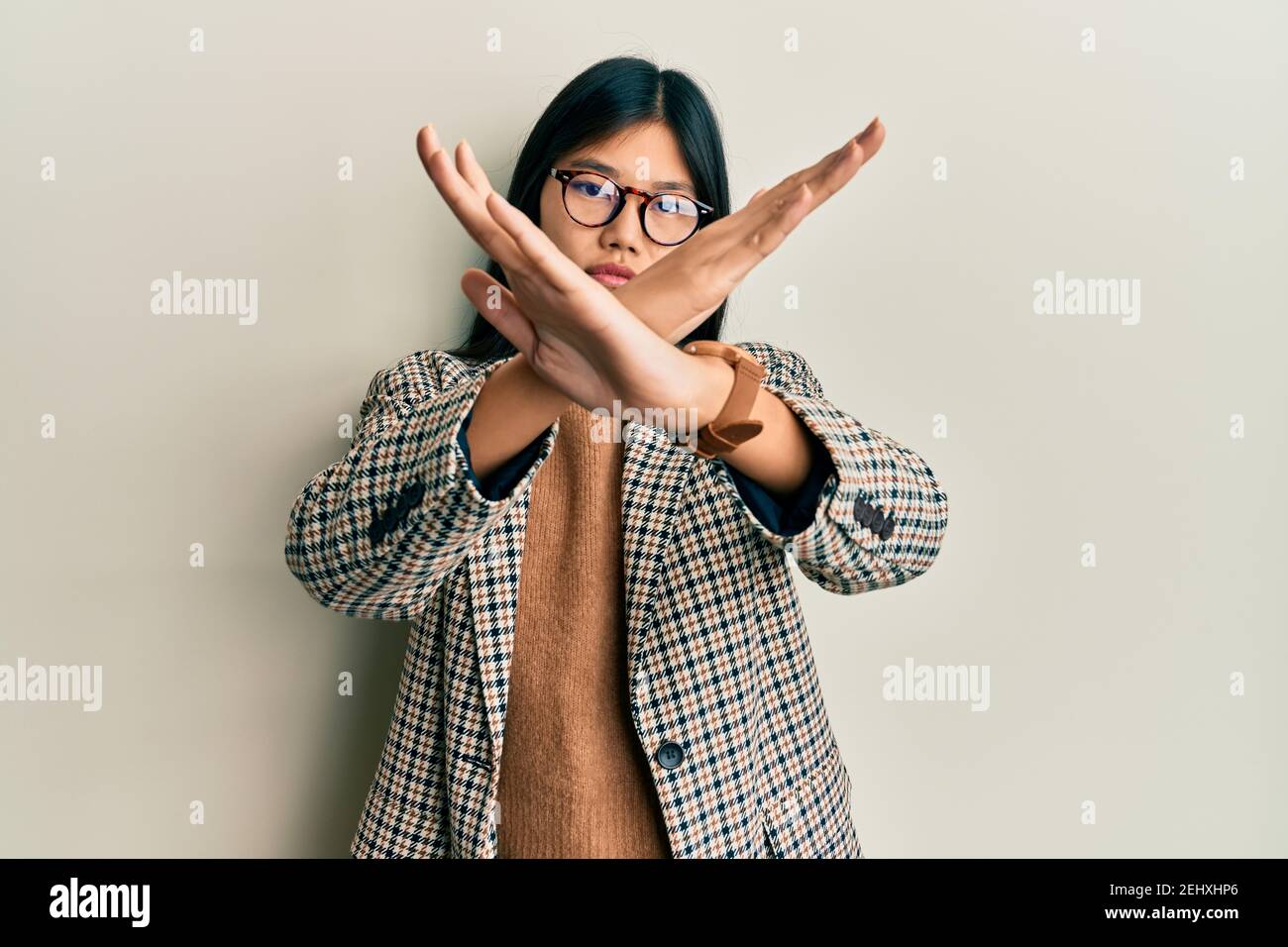 Young chinese woman wearing business style and glasses rejection ...
