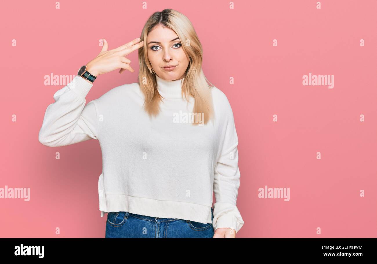 Young caucasian woman wearing casual winter sweater shooting and ...