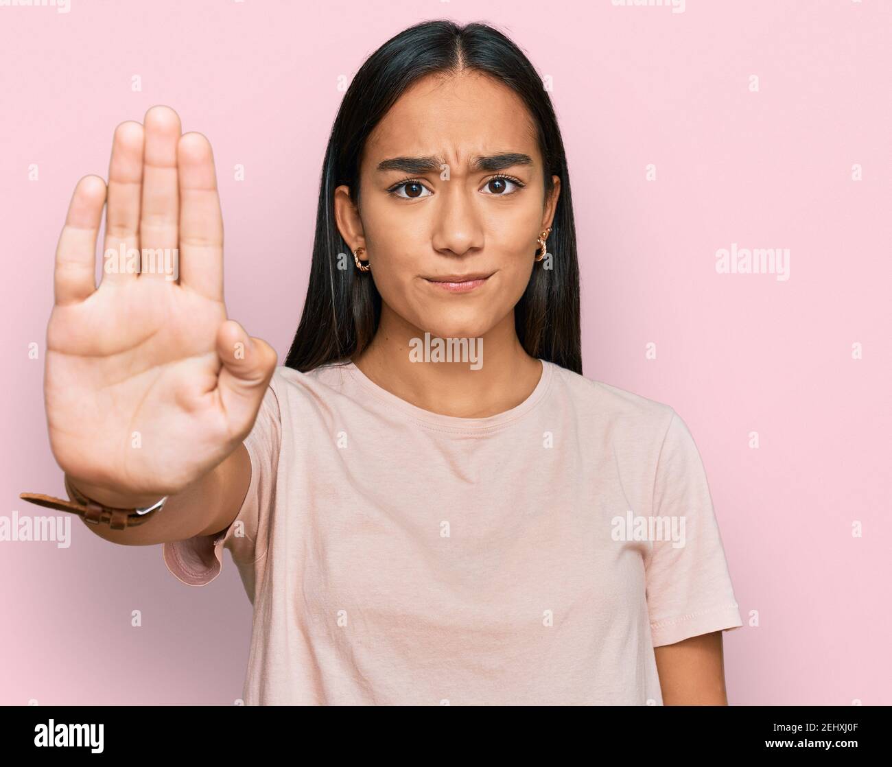 Young asian woman wearing casual clothes doing stop sing with palm of ...
