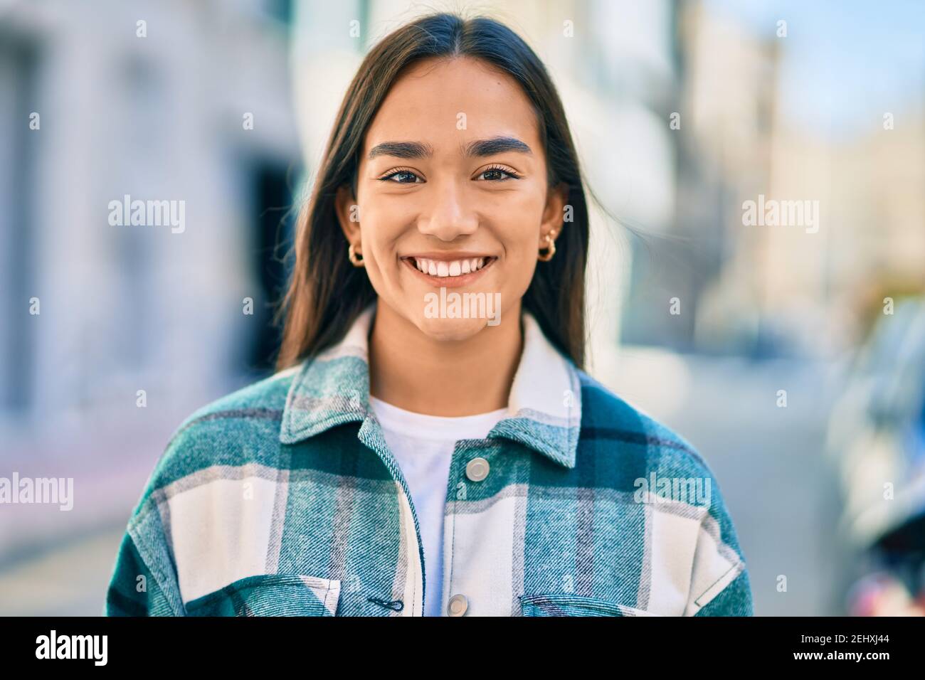Young latin girl smiling happy standing at the city Stock Photo - Alamy