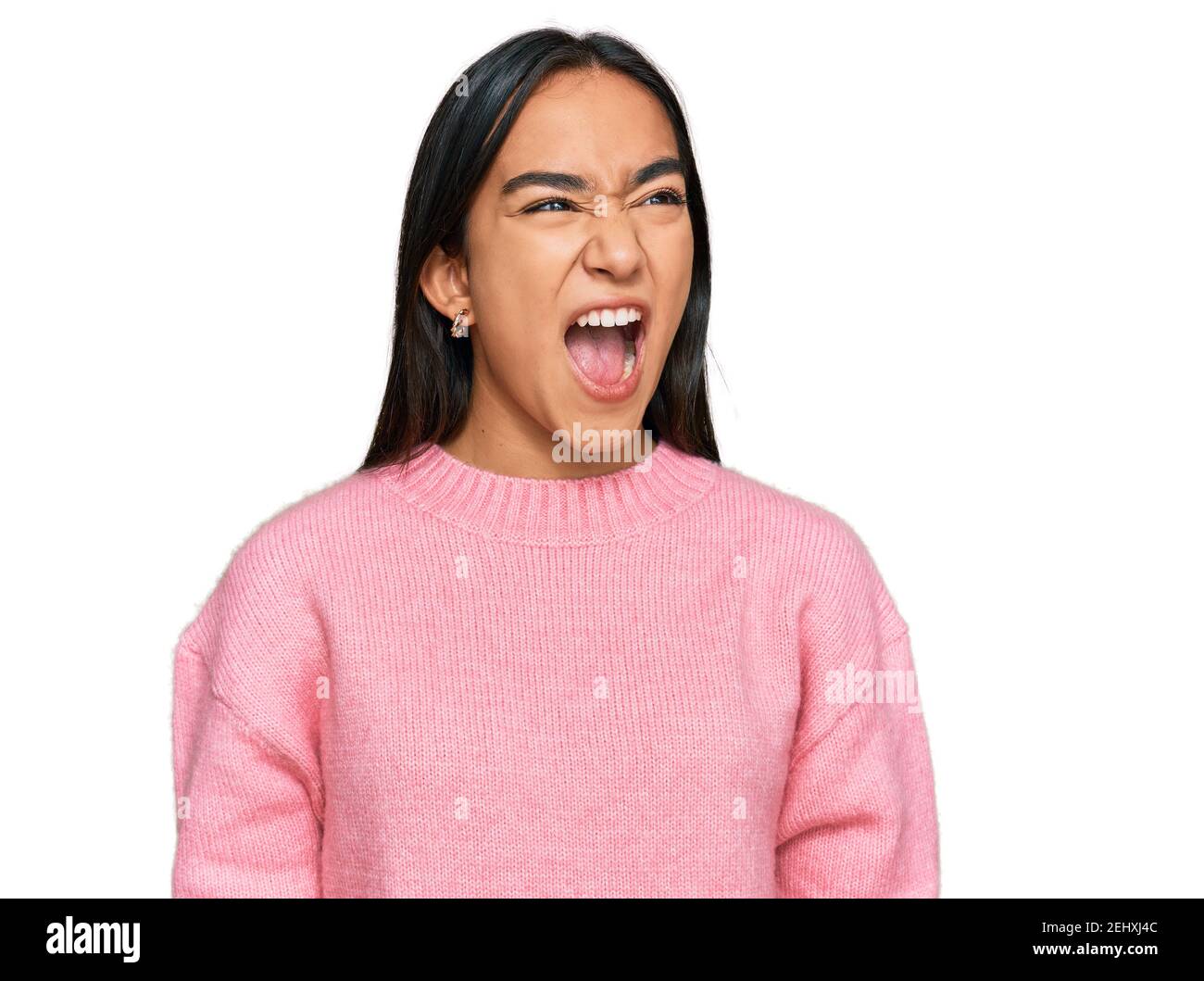Young asian woman wearing casual winter sweater angry and mad screaming ...