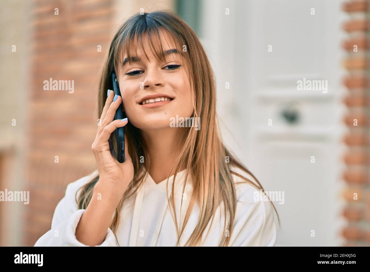Caucasian sporty teenager girl smiling happy talking on the smartphone ...