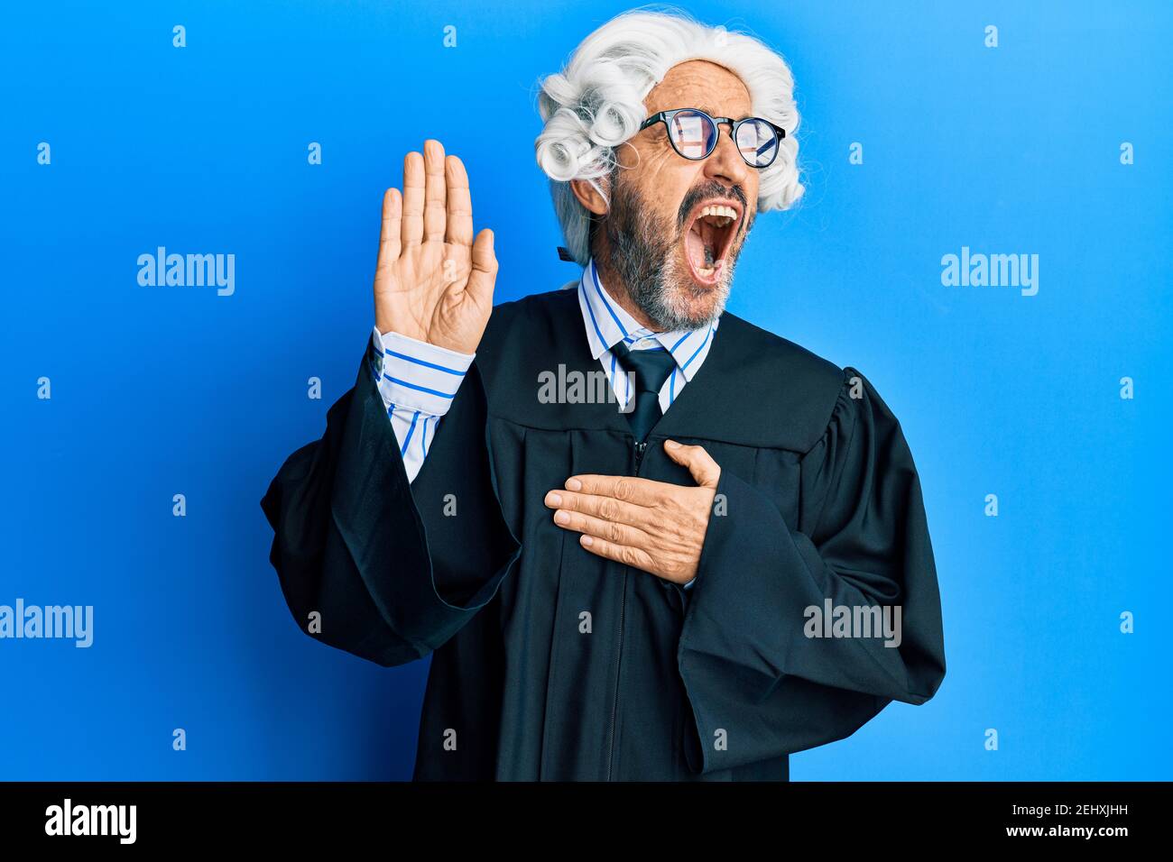 Middle age hispanic man using gavel angry and mad screaming frustrated ...