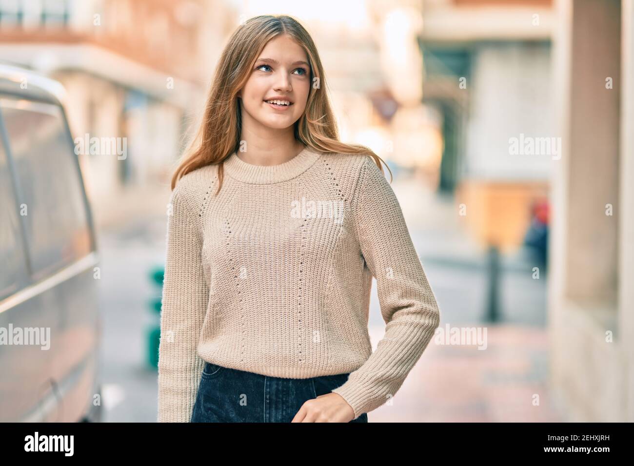 Beautiful caucasian teenager smiling happy standing at the city Stock ...