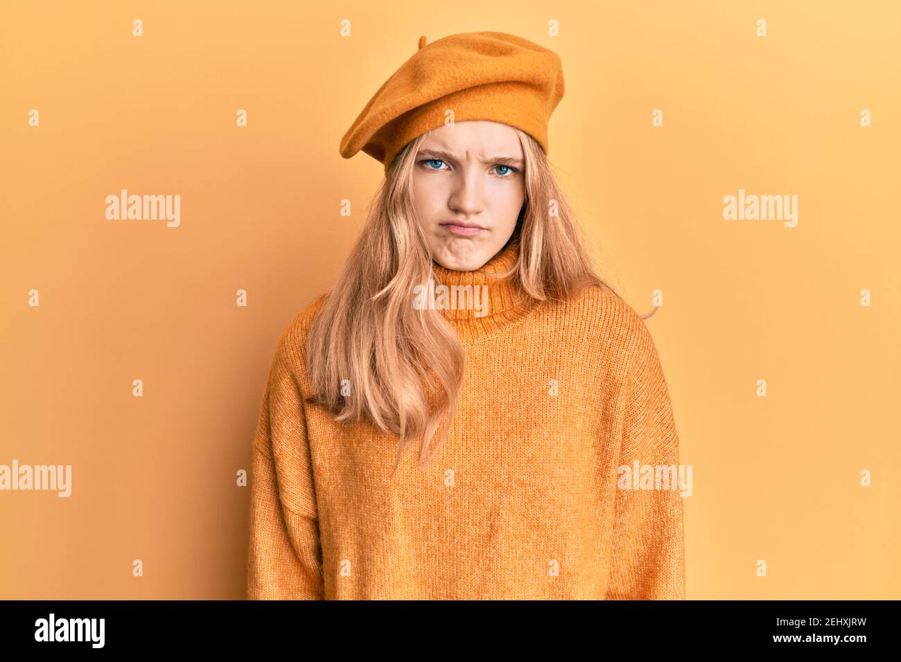 Beautiful young caucasian girl wearing french look with beret skeptic ...