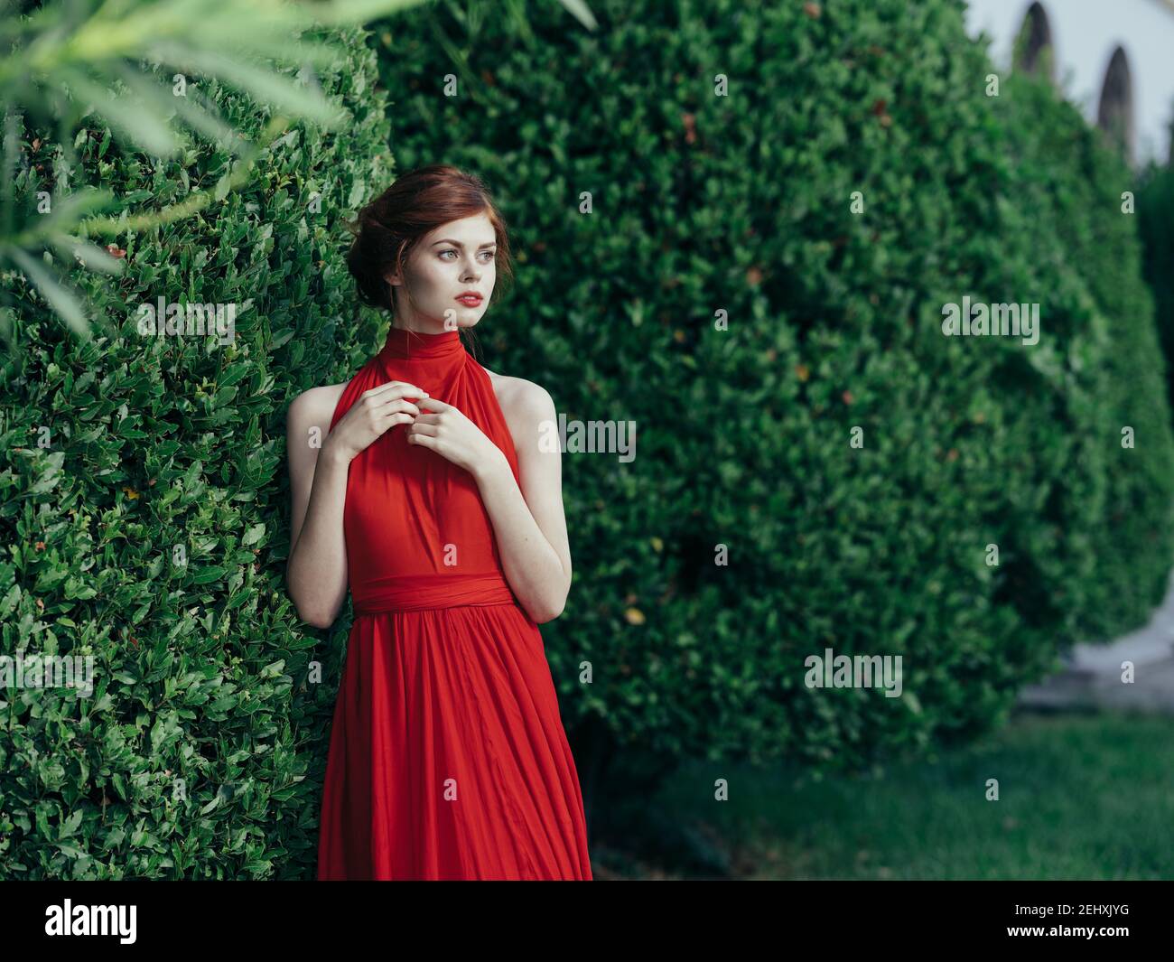 Beautiful lady red dress green bush outdoors walk luxury princess Stock ...