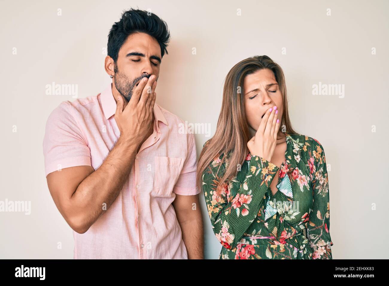 Beautiful young couple of boyfriend and girlfriend together bored ...