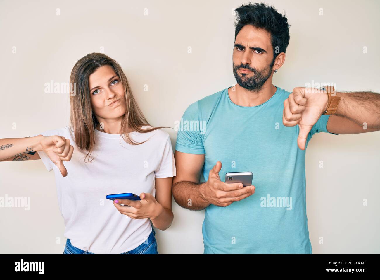 Beautiful young couple of boyfriend and girlfriend using smartphone ...