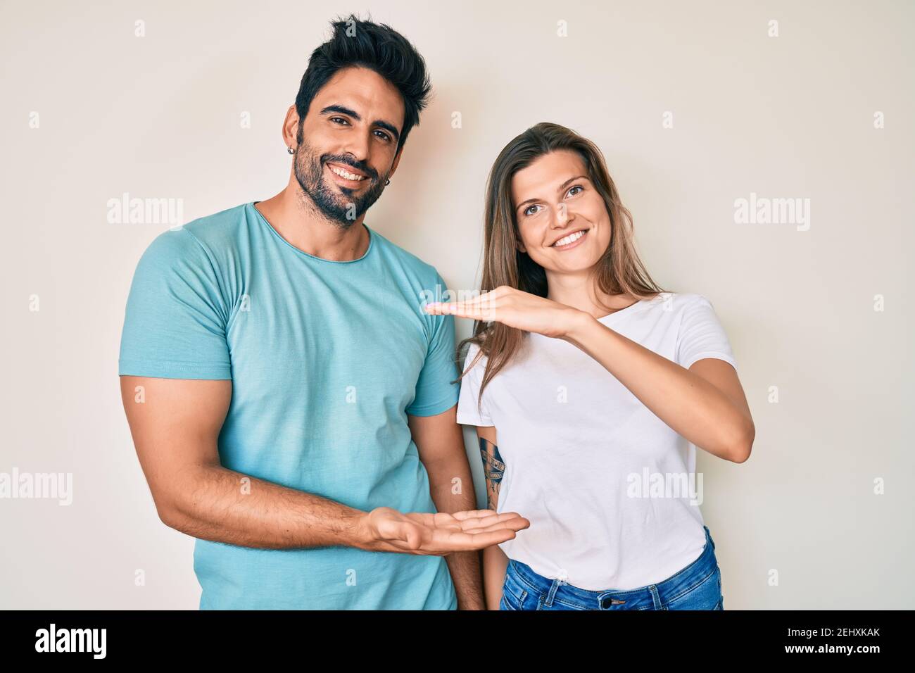 Beautiful young couple of boyfriend and girlfriend together gesturing ...