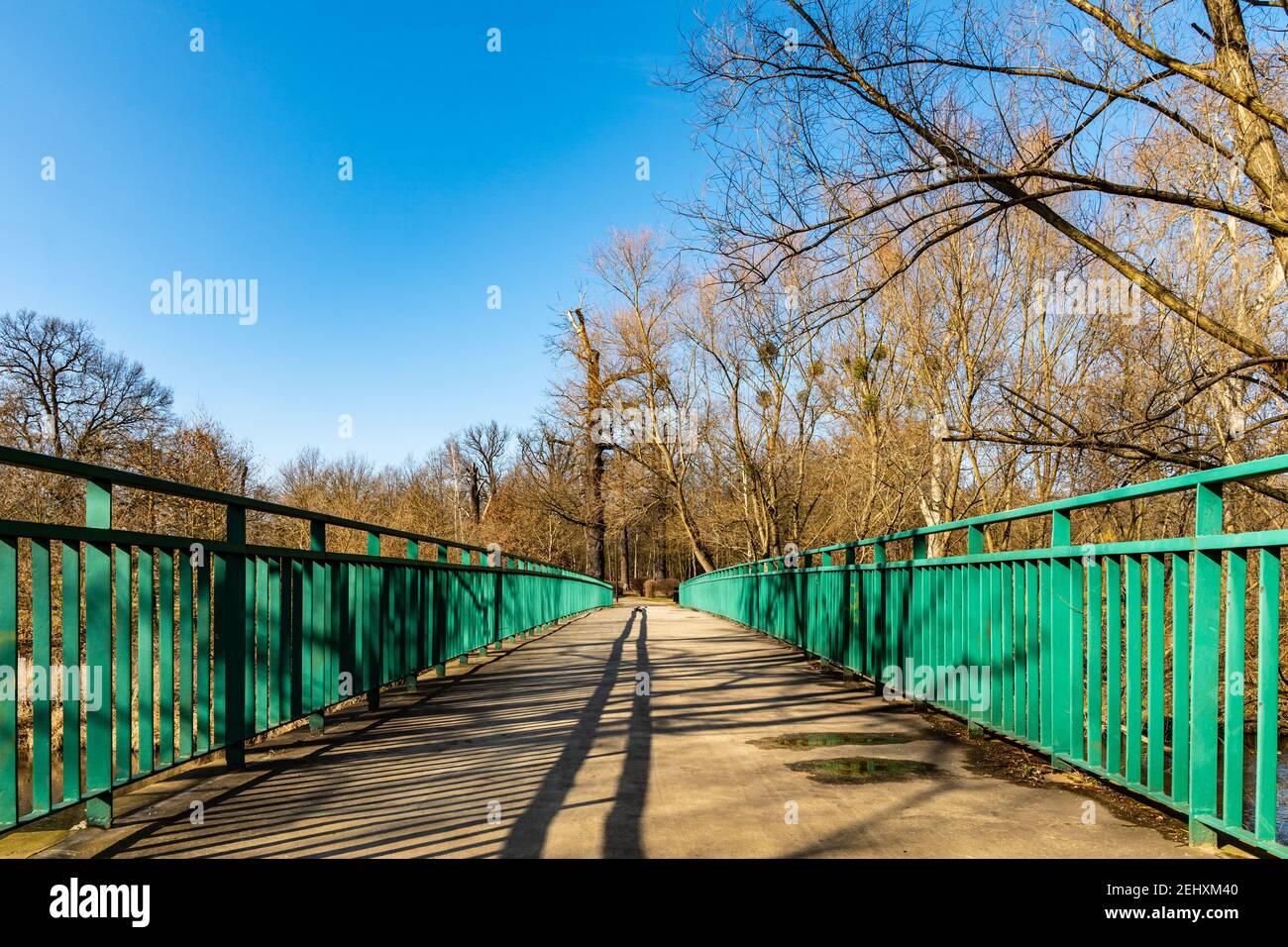 Long concrete bridge over river with green metal railing Stock Photo ...