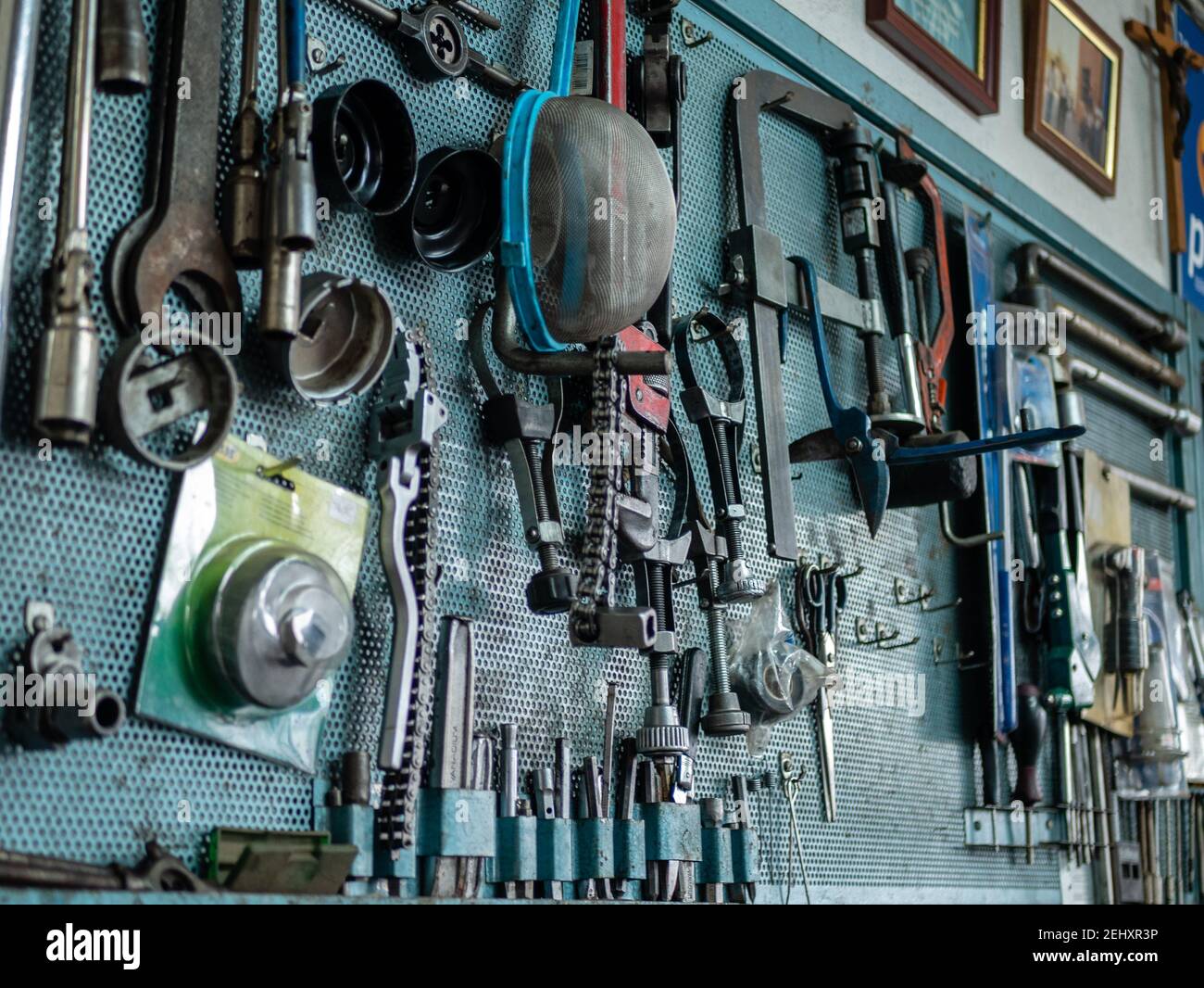 Tools hanging on the wall in the workshop Stock Photo - Alamy