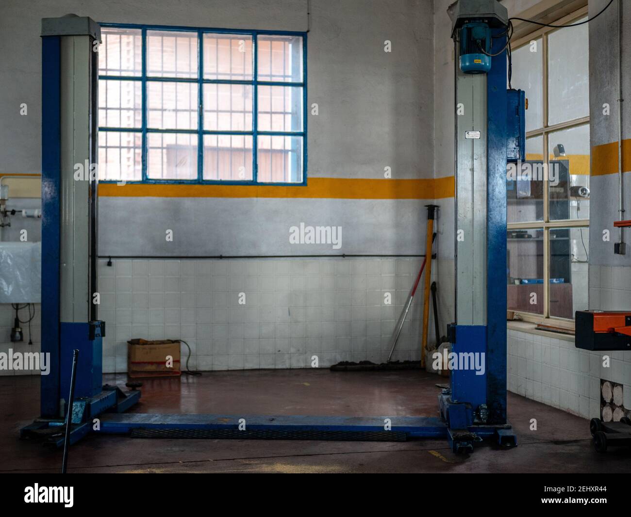 Electric lift for a car in the garage Stock Photo - Alamy