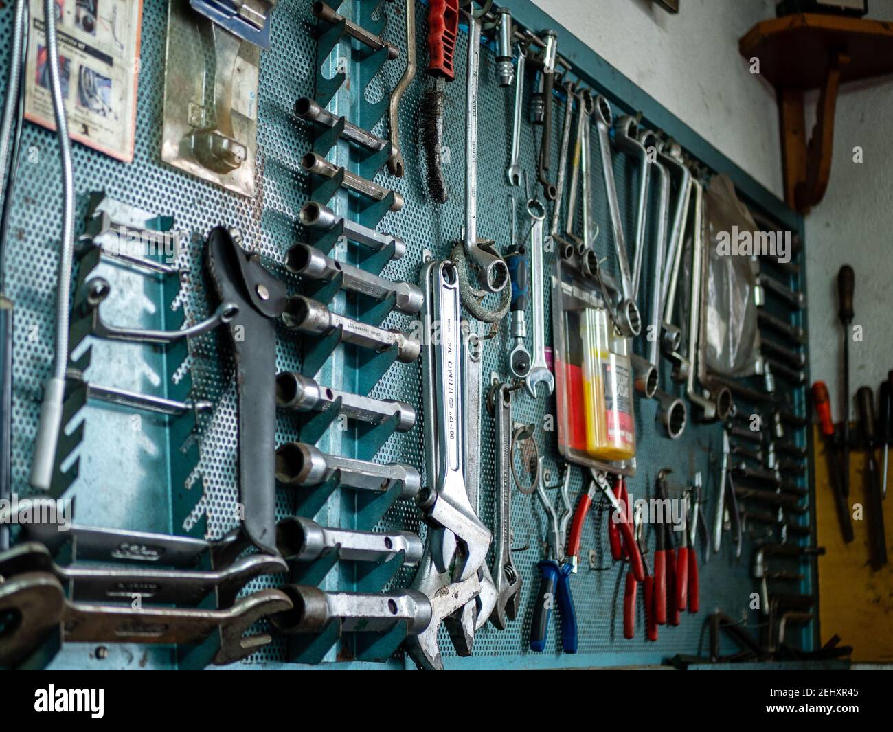 Tools hanging on the wall in the workshop Stock Photo - Alamy