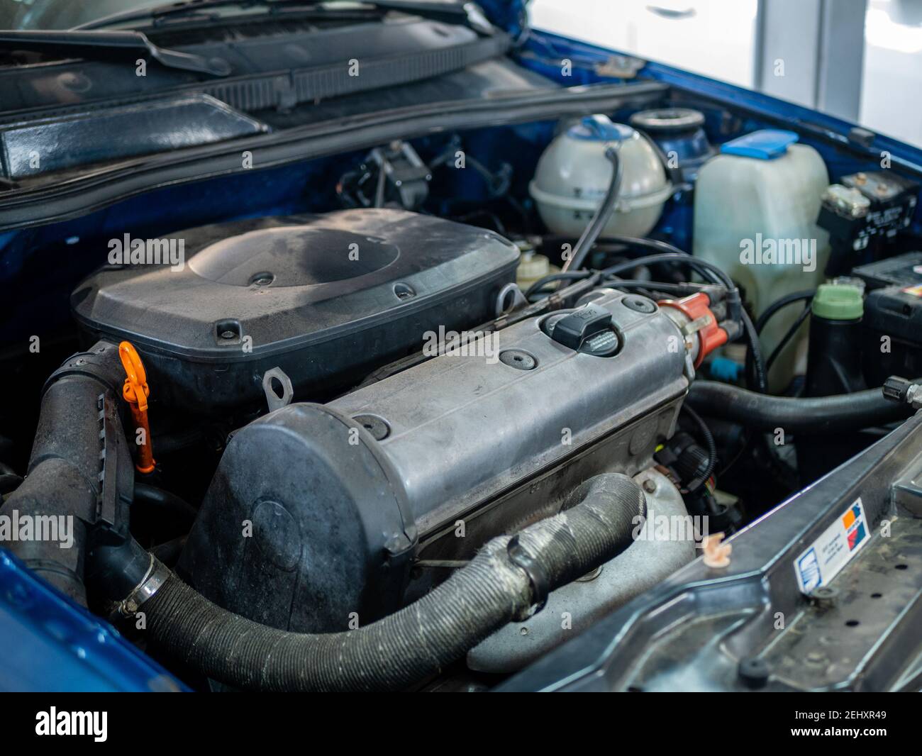 Car with an open hood in the auto repair shop Stock Photo - Alamy