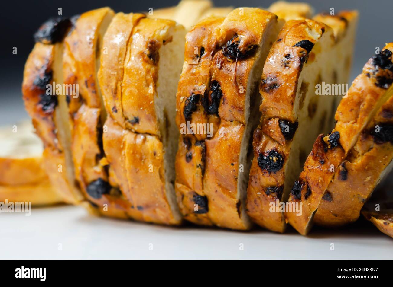 Fruit loaf with sultanas and orange flavored pieces on the white ...