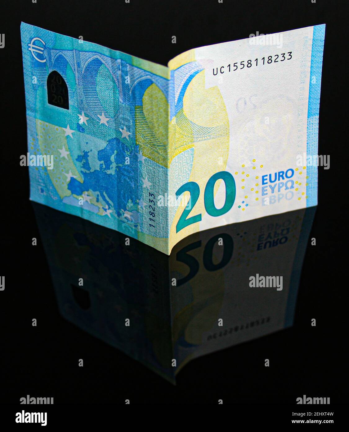 Twenty euro banknote isolated on a black background Stock Photo - Alamy