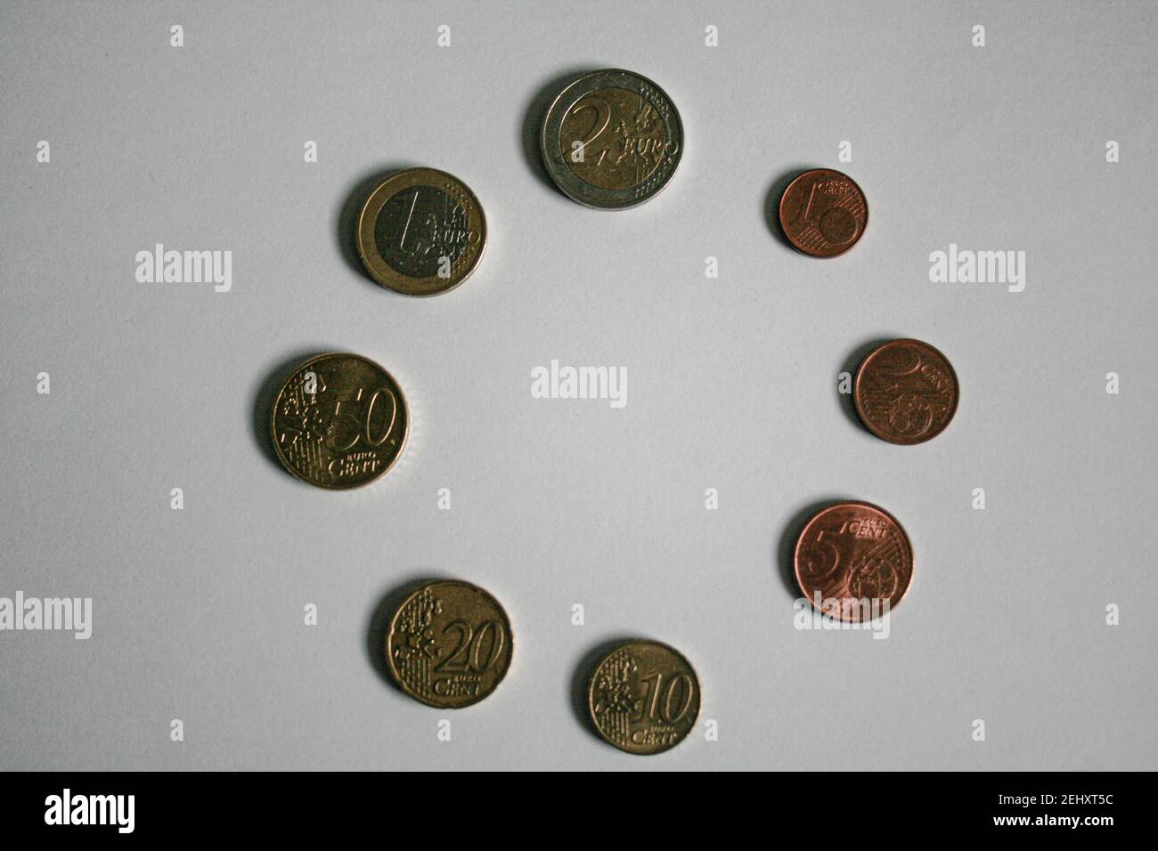 Top view of euro coins forming a circle on a white surface Stock Photo ...