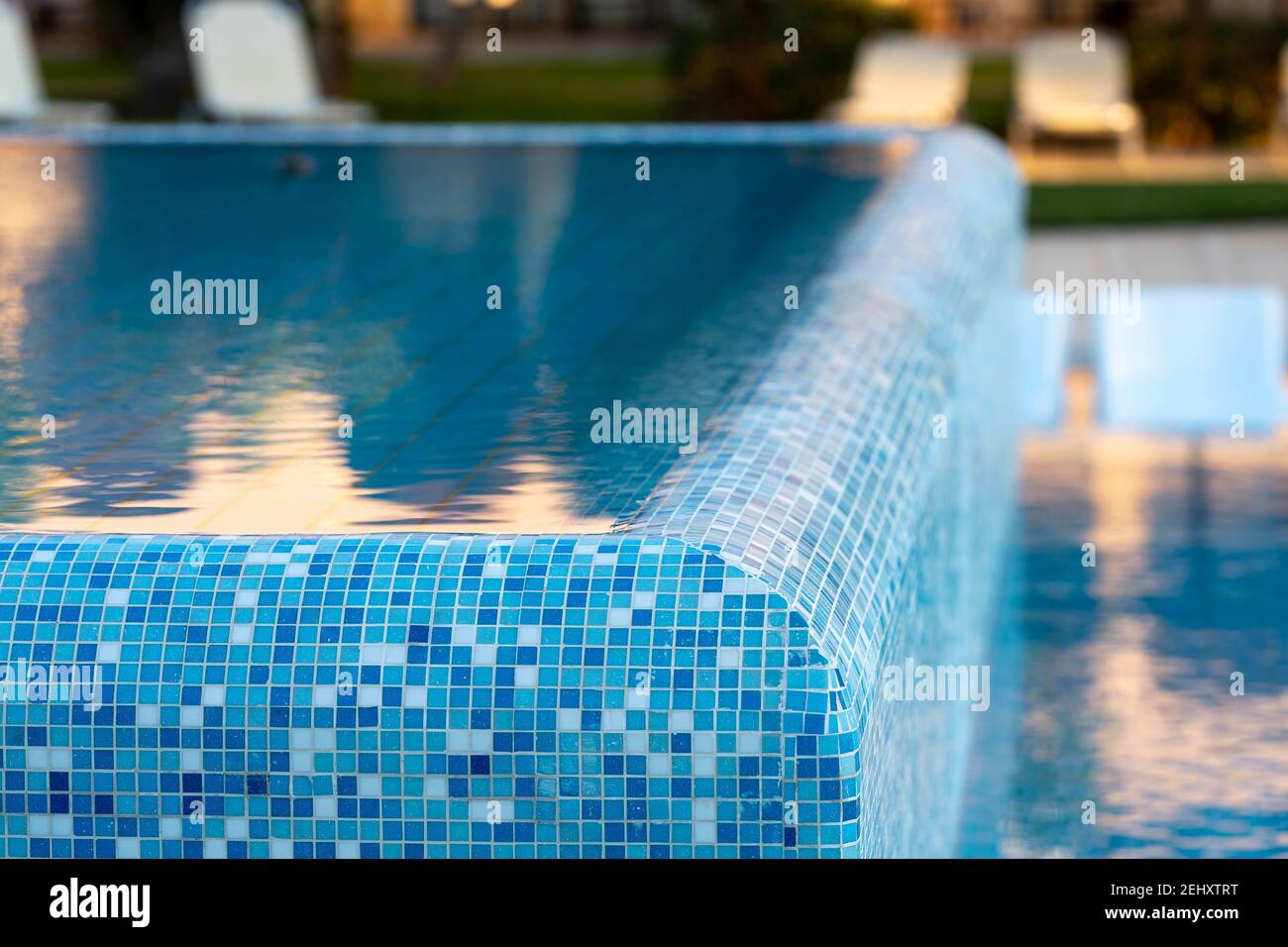 Outdoor swimming pool with blue mosaic tiles Stock Photo - Alamy