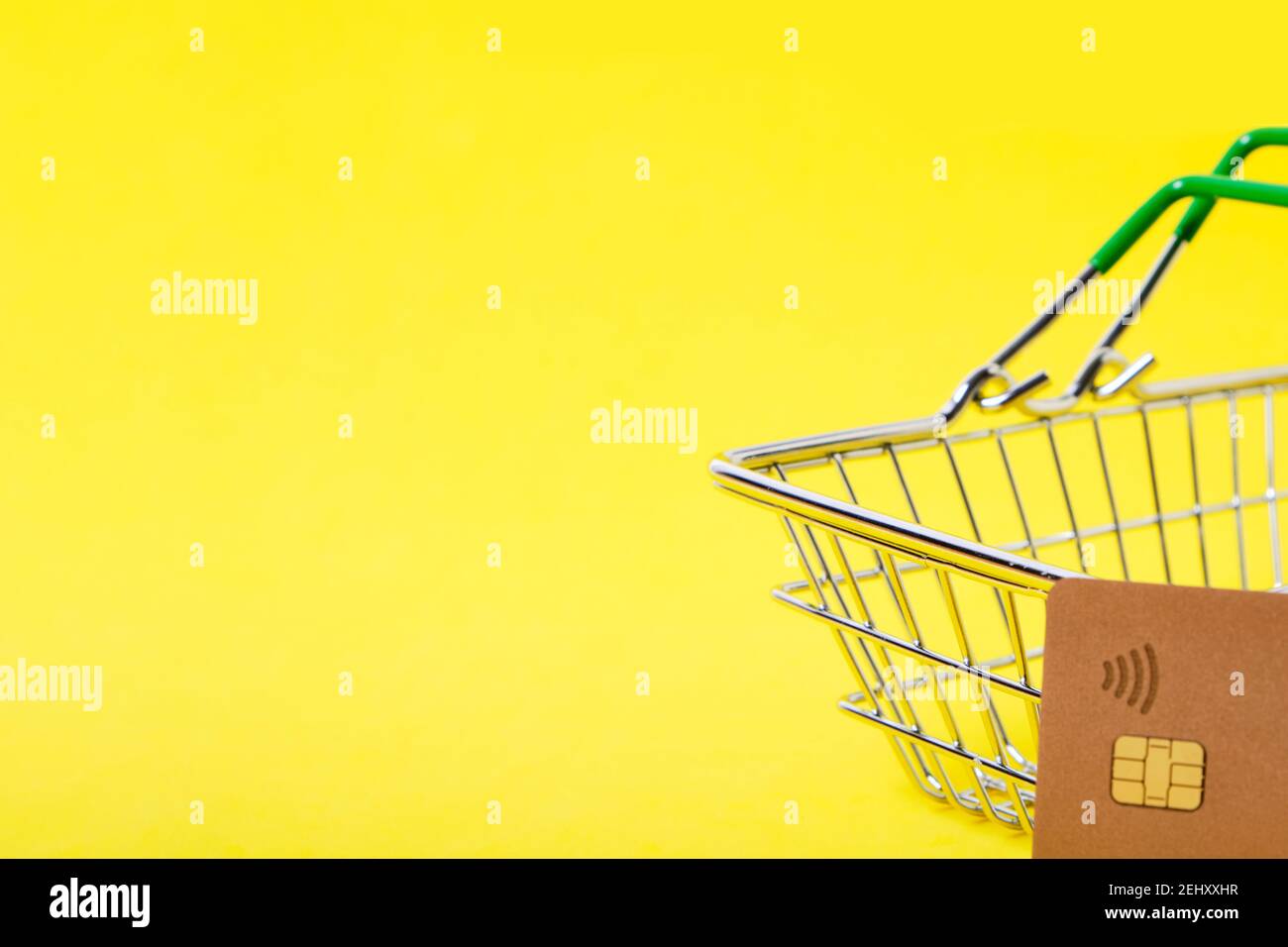 Shopping cart and bank card on yellow background.Online shopping Stock ...