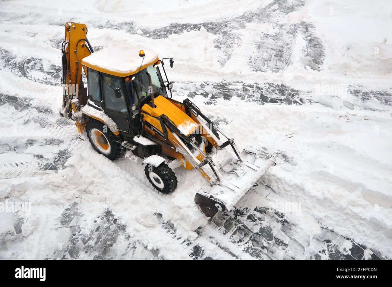 Removing snow accumulations using a tractor with attachments Stock ...