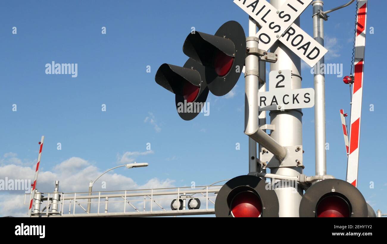Level crossing warning signal in USA. Crossbuck notice and red traffic ...