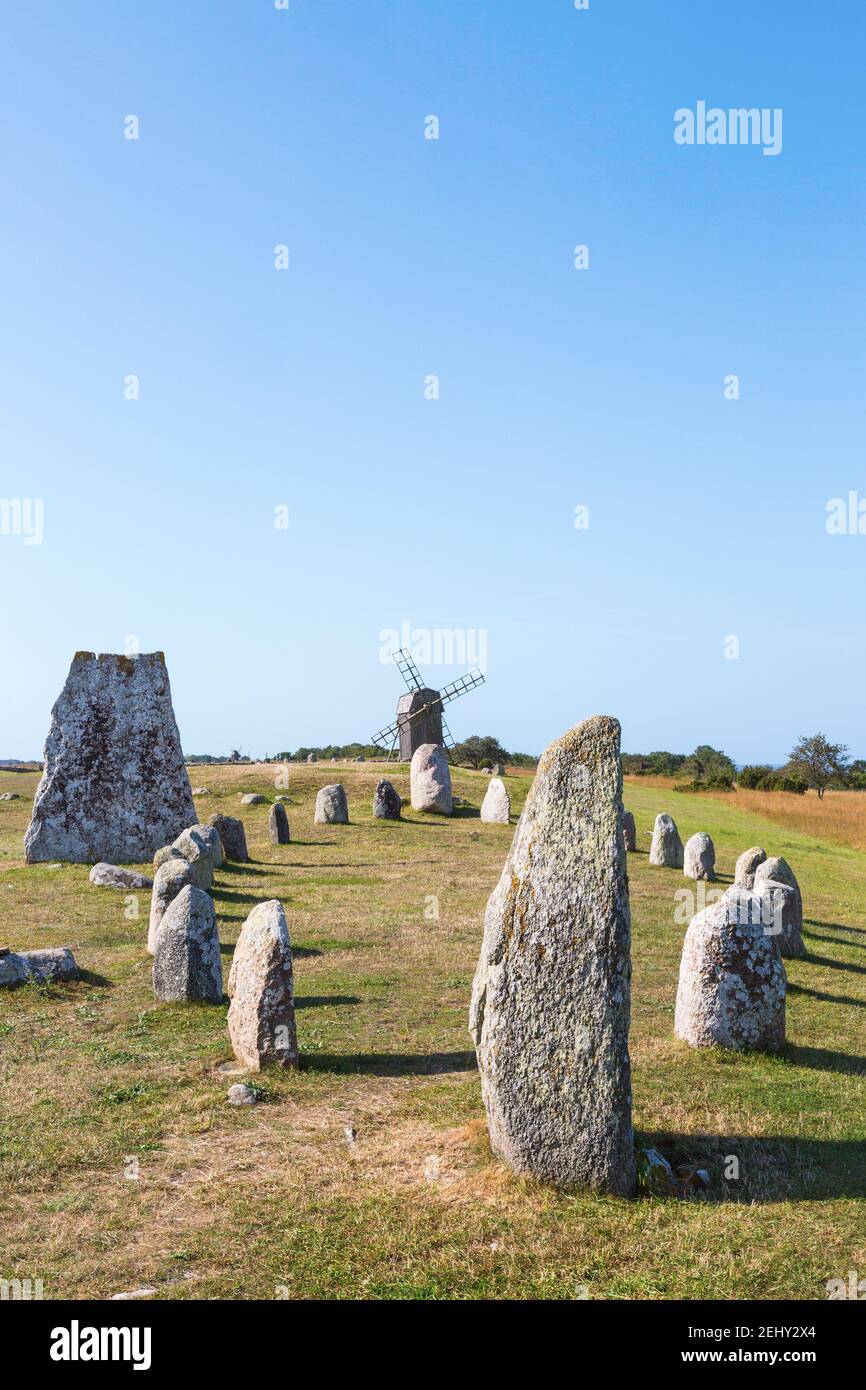 Stone ship on a meadow with a windmill Stock Photo - Alamy