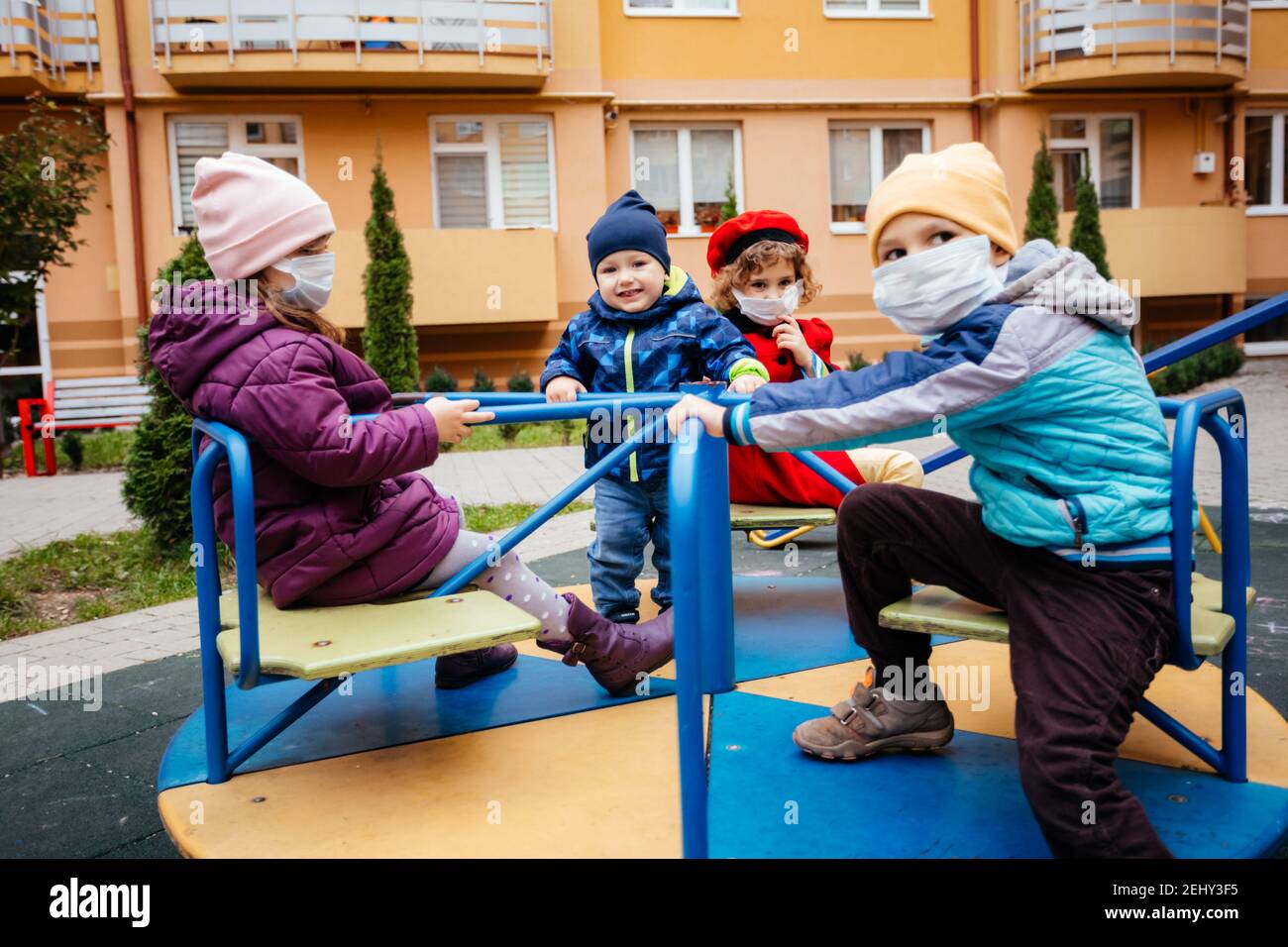The group of children with a medical masks in a city playground Stock ...
