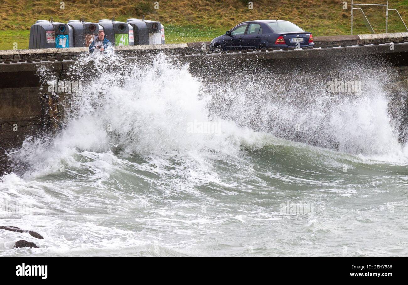 Man watching storm waves breaking against sea wall Stock Photo - Alamy