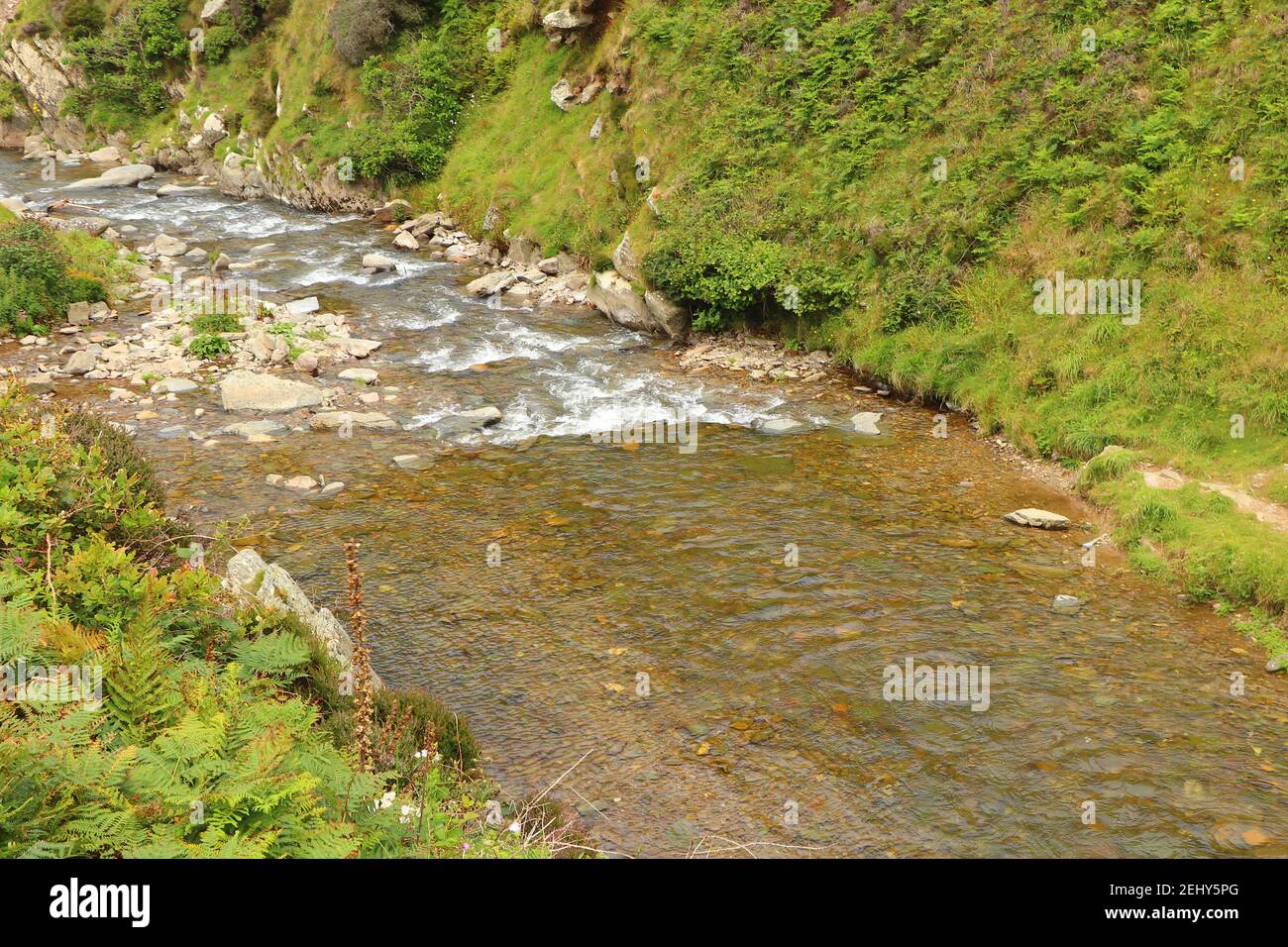 Heddon river flowing through the valley and over rocky ground Stock ...