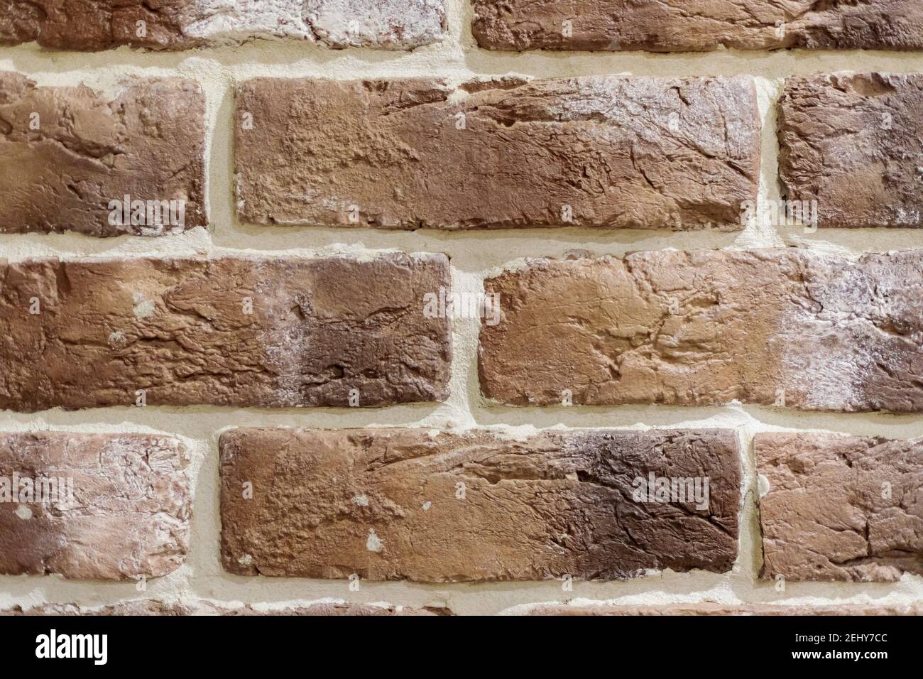 Wall with brickwork under the old destroyed brick of light beige. White ...