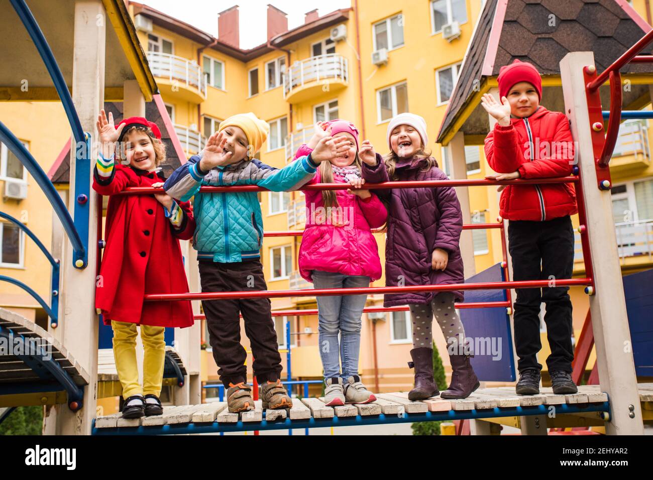 the smiling kids are standing together on the playground equipment ...