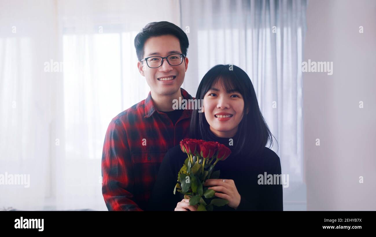 Happy couple holding flower hi-res stock photography and images - Alamy