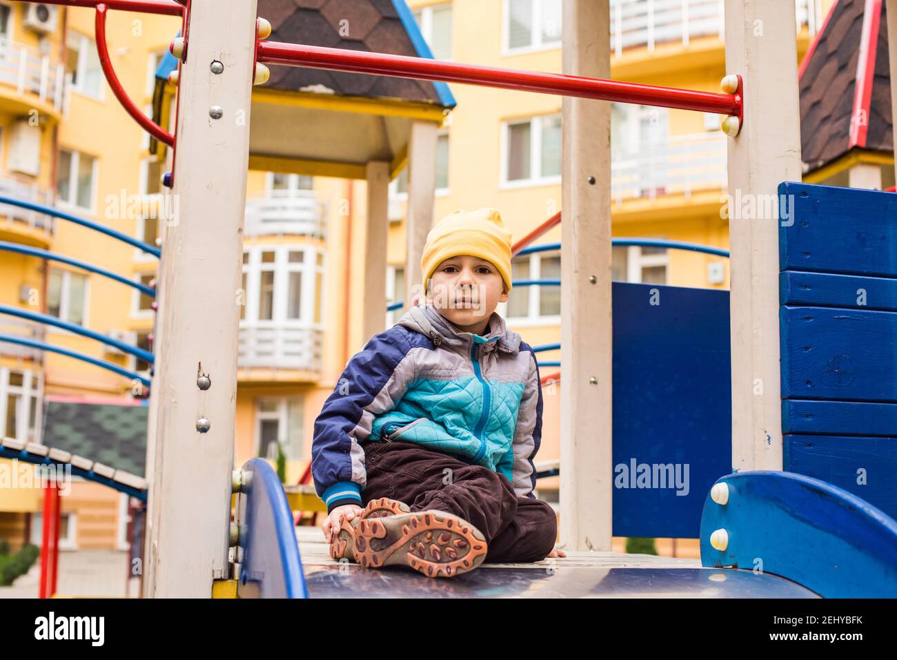 Sad boy play alone at playground outdoors Stock Photo - Alamy