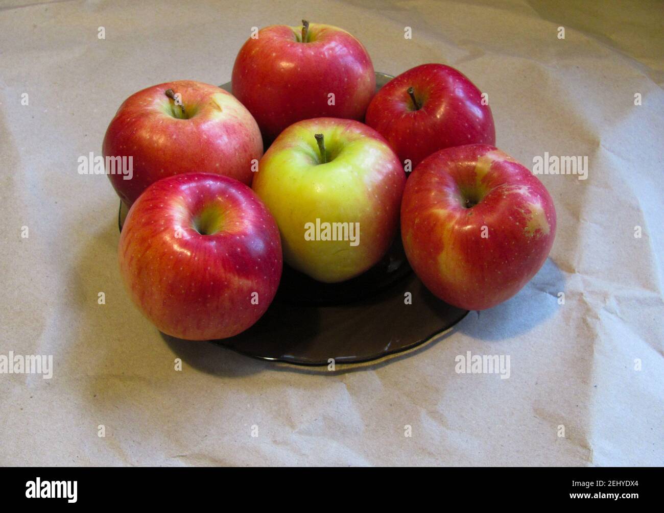 large juicy red florina apples on a black plate Stock Photo - Alamy