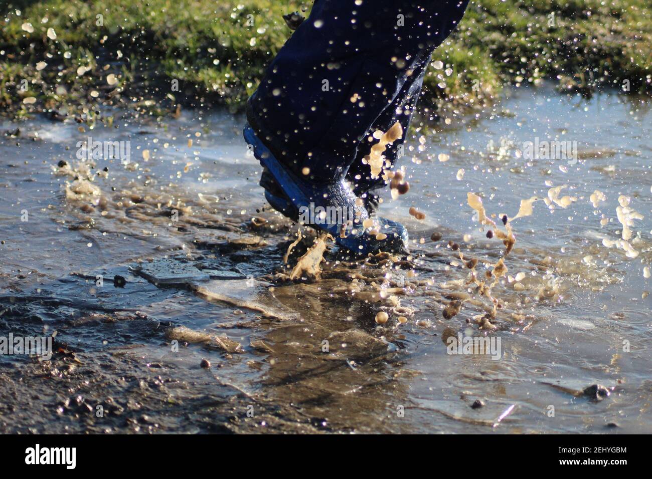 Child splashing in a rainy puddle Stock Photo - Alamy