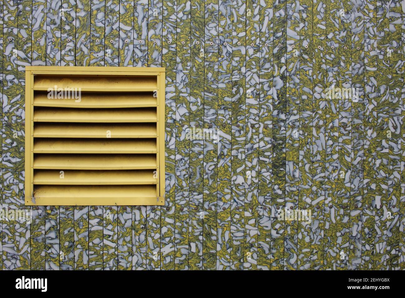 Grate on colourful wall Stock Photo - Alamy