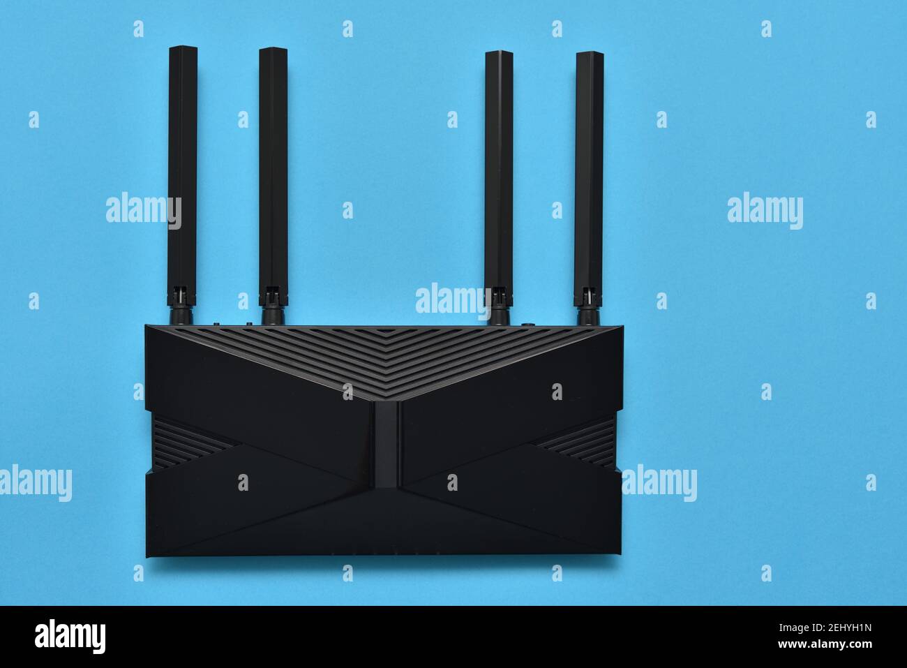 Modern wi-fi 6 router on a blue background Stock Photo - Alamy
