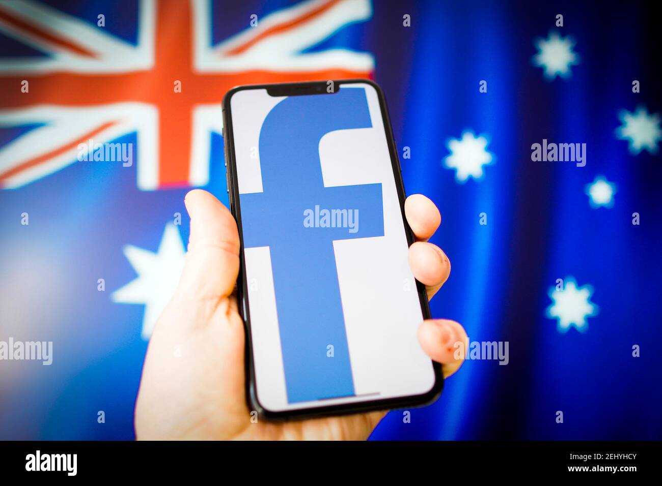 The Facebook logo is seen with the Australian flag in the background in ...