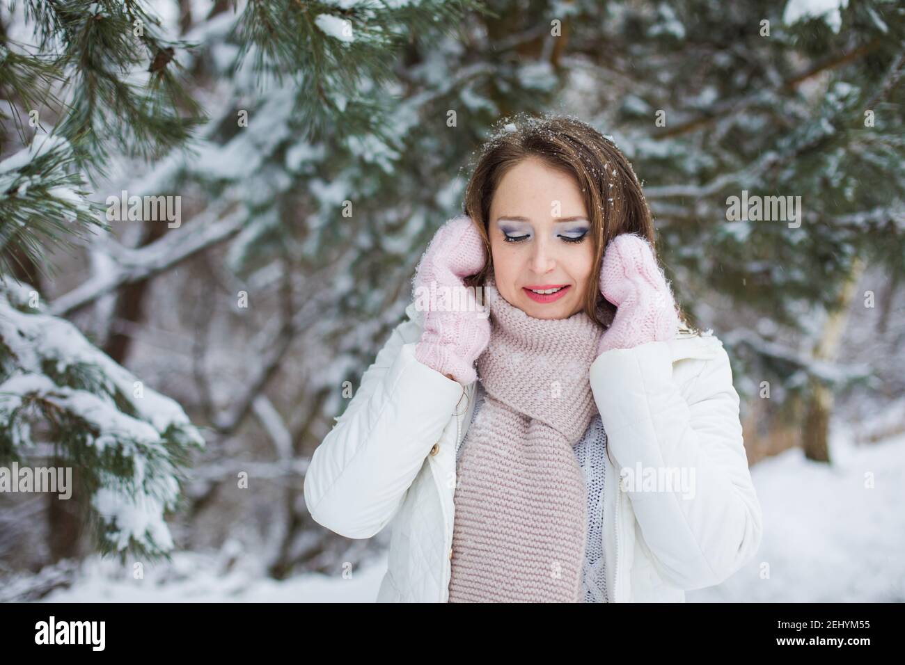 Woman look down and miles under the snow covered tree Stock Photo - Alamy