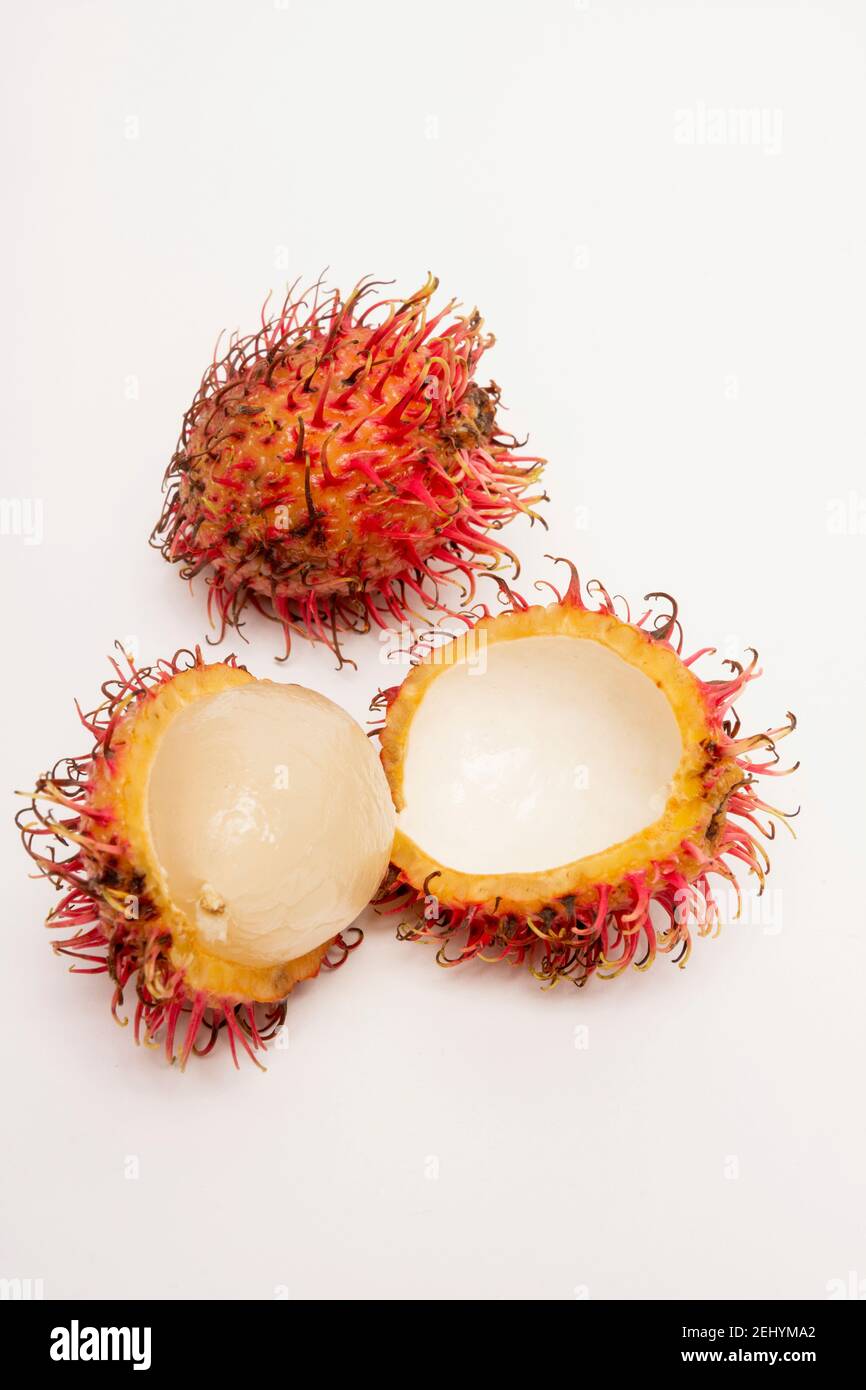 Fresh rambutan fruit displayed with open and closed varieties on a ...