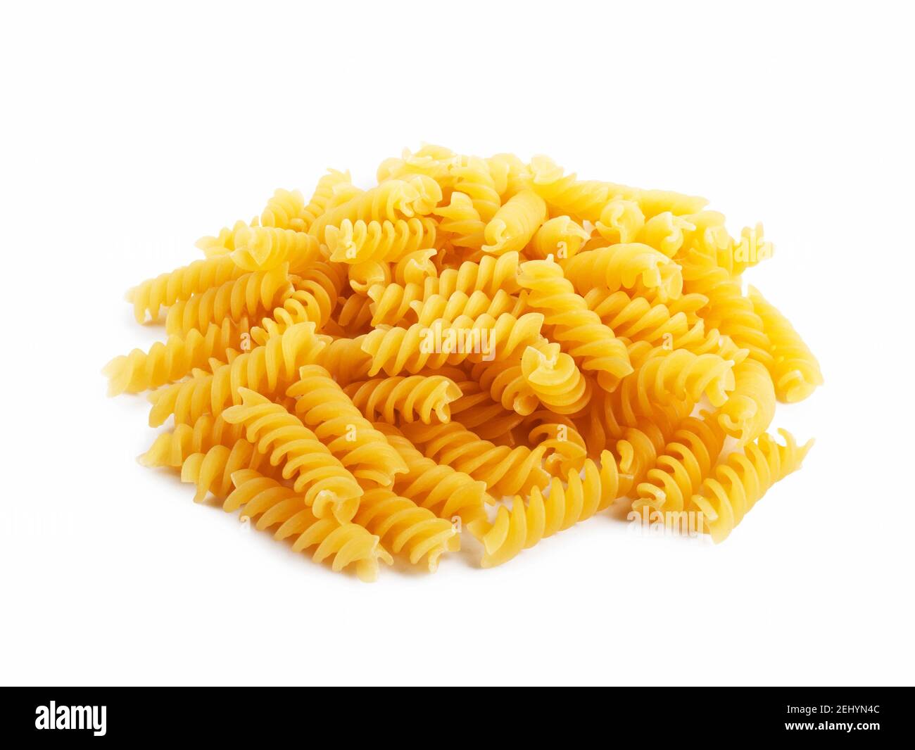 Pile of fusilli pasta isolated on white background Stock Photo - Alamy